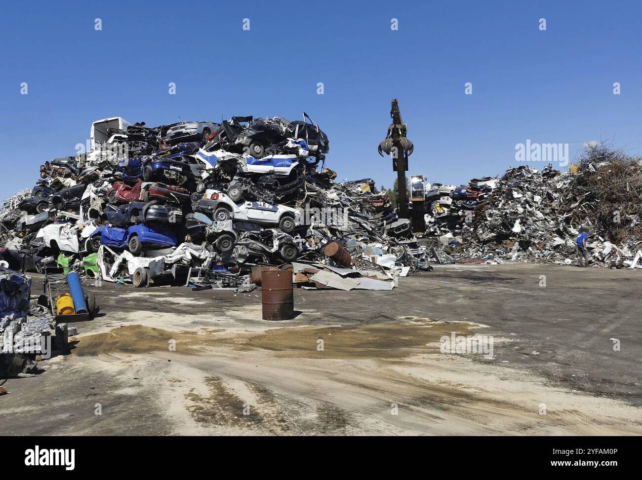 Pile of various scrap cars and other metals on a junk yard field ready ...