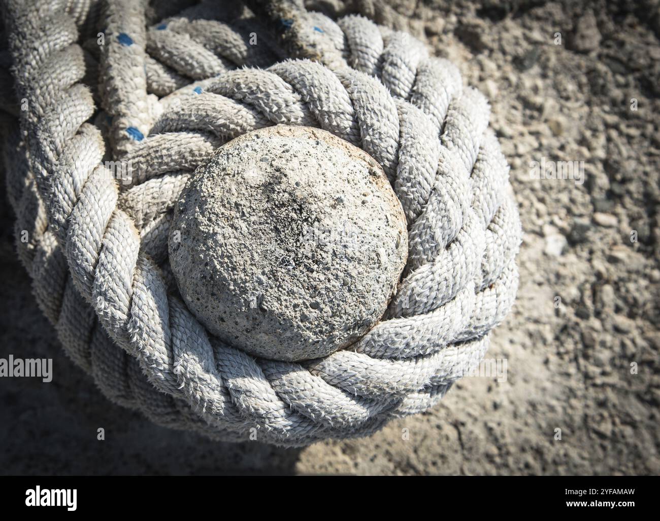 Details of a twisted Ship mooring strong rope on a bollard for securing ...
