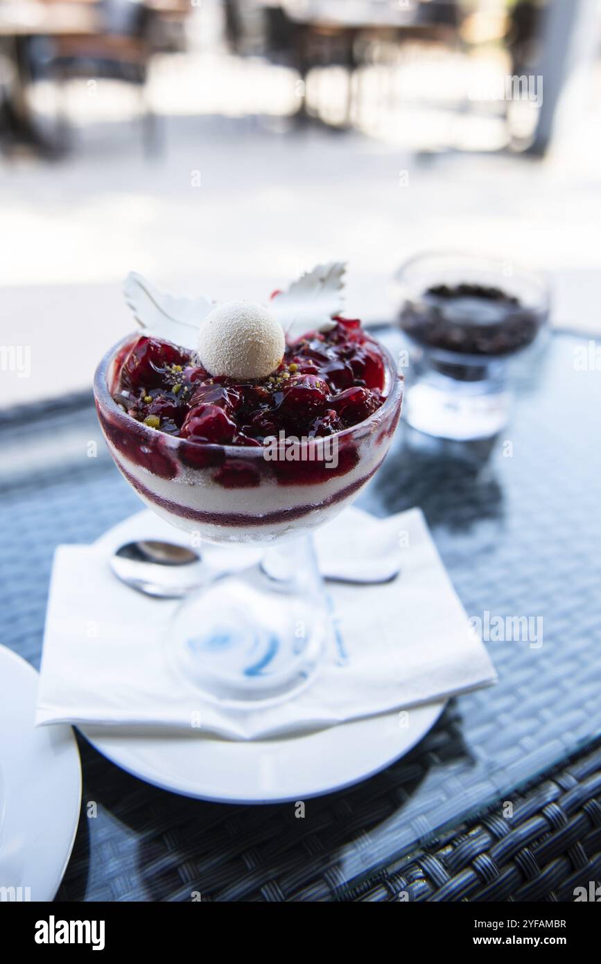 Delicious sweet mousse cake with chocolate garnishes and a piece of red ...