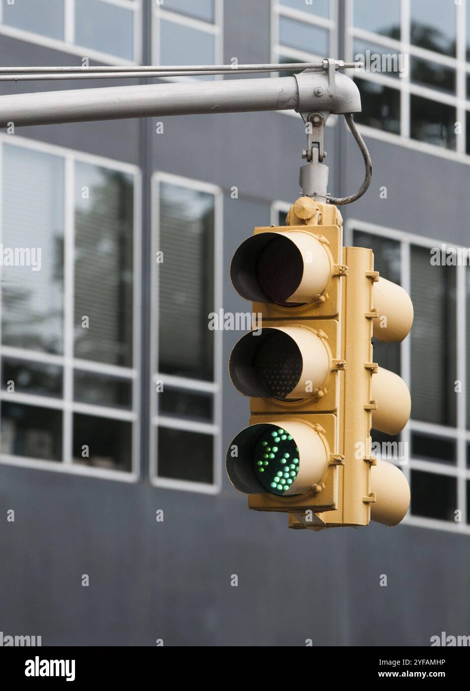 Yellow Traffic light with the green pass sign flashing from New York ...