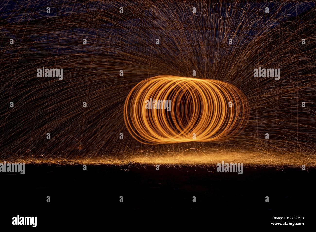 Orange circle moving bright fire light trails on black background Stock ...