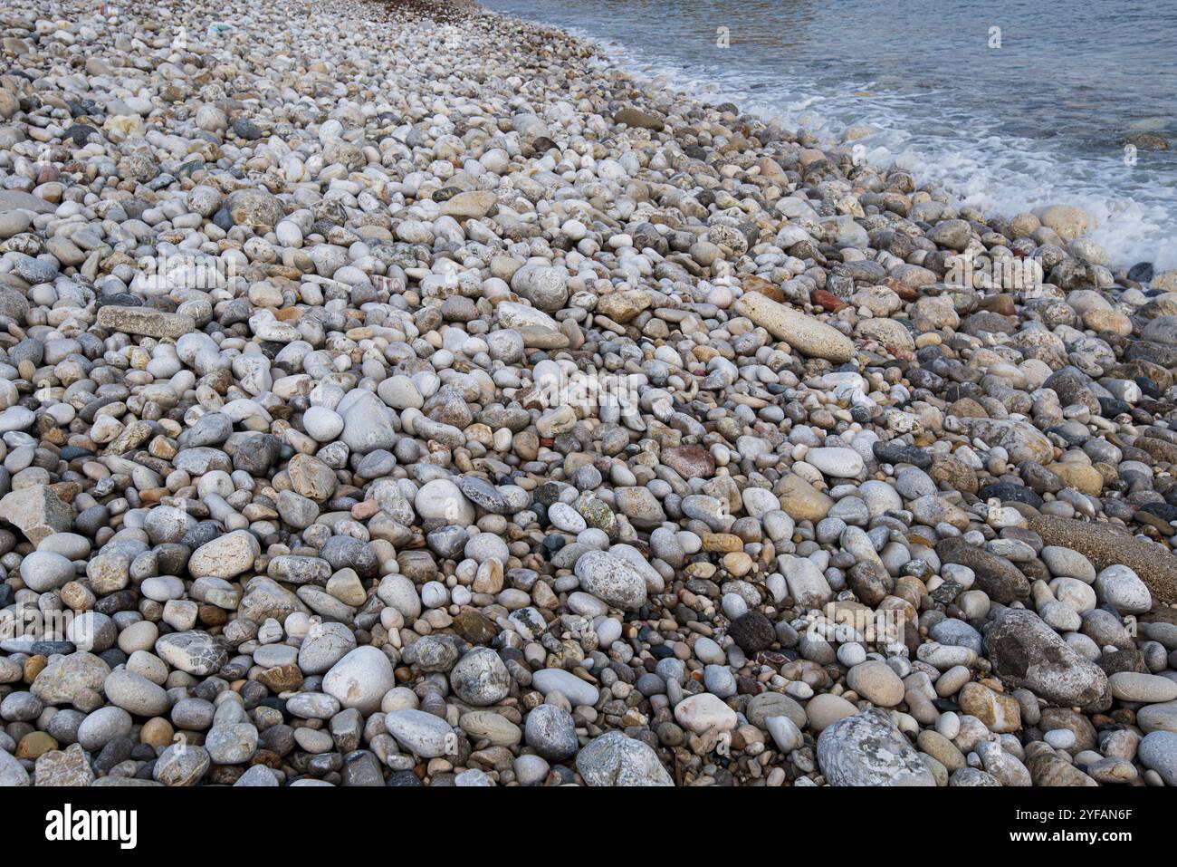 Beautiful and colourful sea pebbles on the beach creating a beautiful ...
