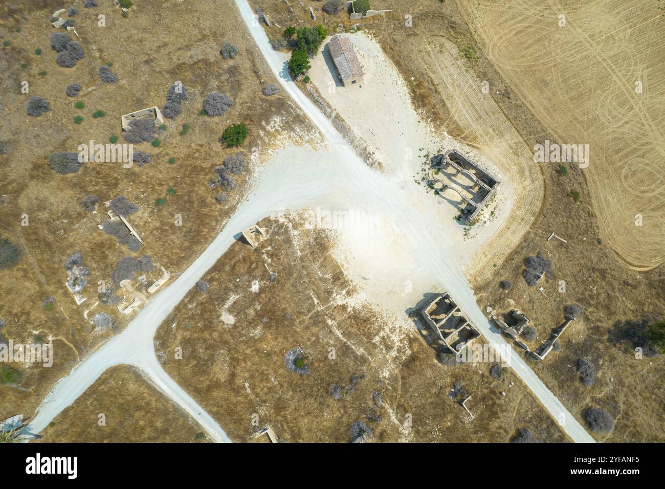 Aerial view drone photograph of an abandoned and deserted village with ruins of houses. Agios ...