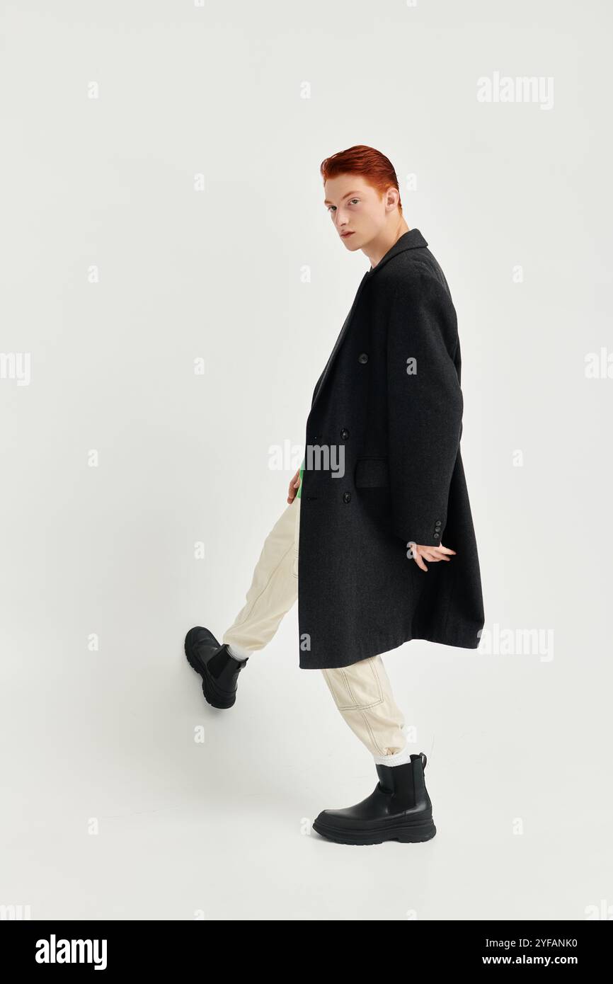 Dressed in an elegant winter coat, a handsome man poses confidently ...