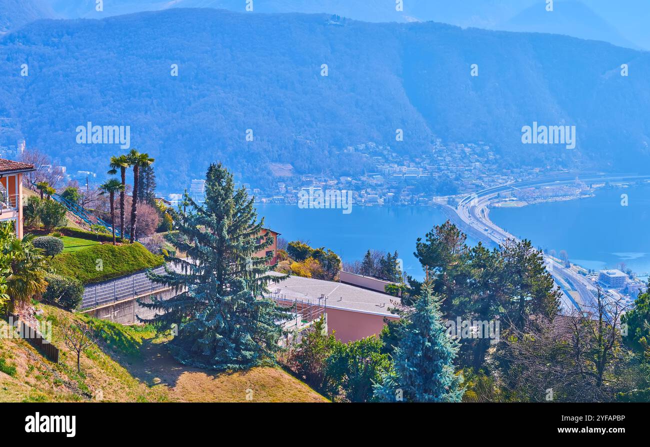 The beautiful green gardens of Carona with tall conifer trees in front ...