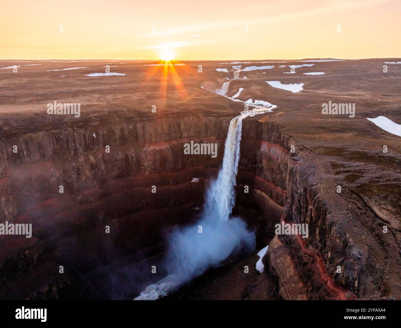 Aerial view on Hengifoss waterfall with red stripes sediments and old ...