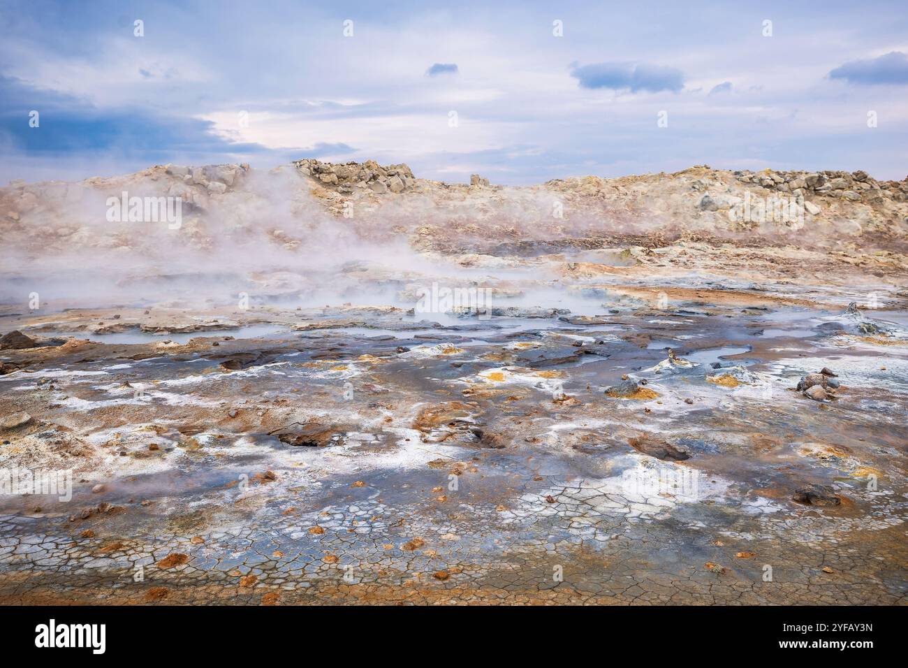 Boiling mudpots in the geothermal area Hverir and cracked ground around ...
