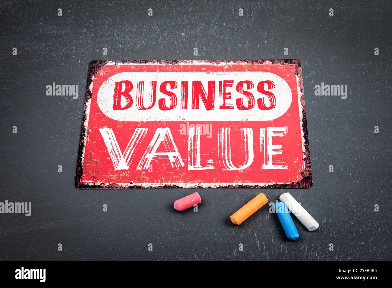 Business Value. Sign with text and colored pieces of chalk on a dark ...