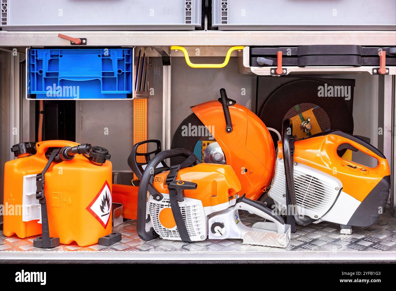 Fuel containers, safety gear, chainsaws organized on metal shelf ...