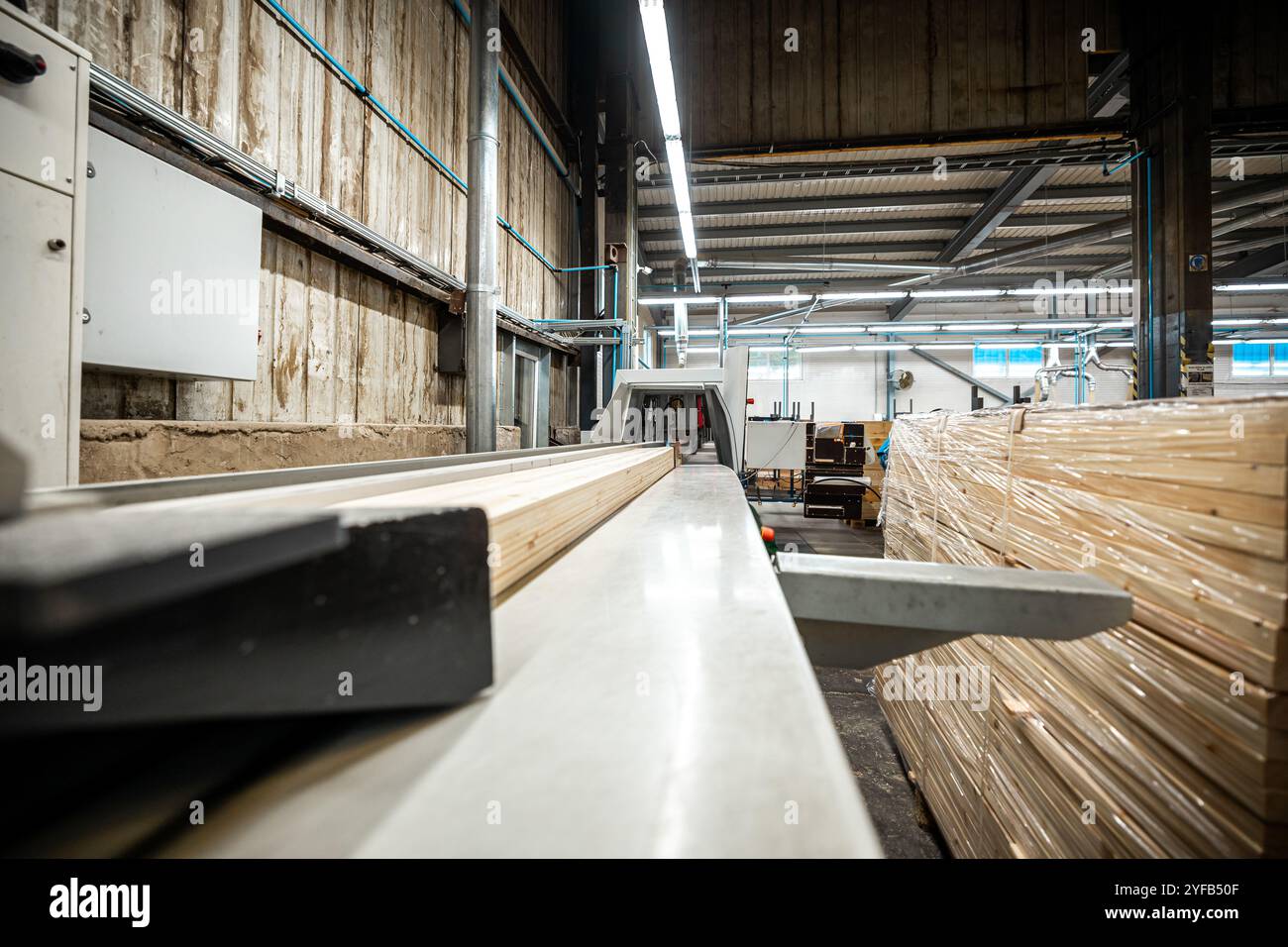 A workbench in a woodworking factory, with wooden beams and tools ready ...