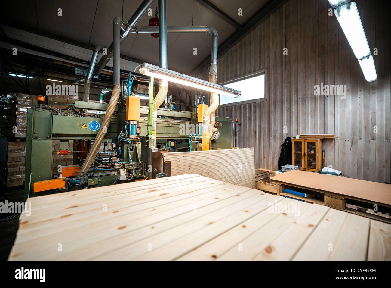 Close-up of an industrial woodworking machine in action, processing ...