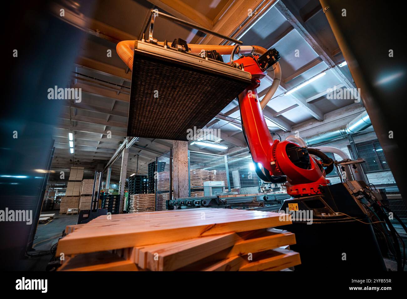 A robotic arm in a woodworking factory, equipped with suction ...