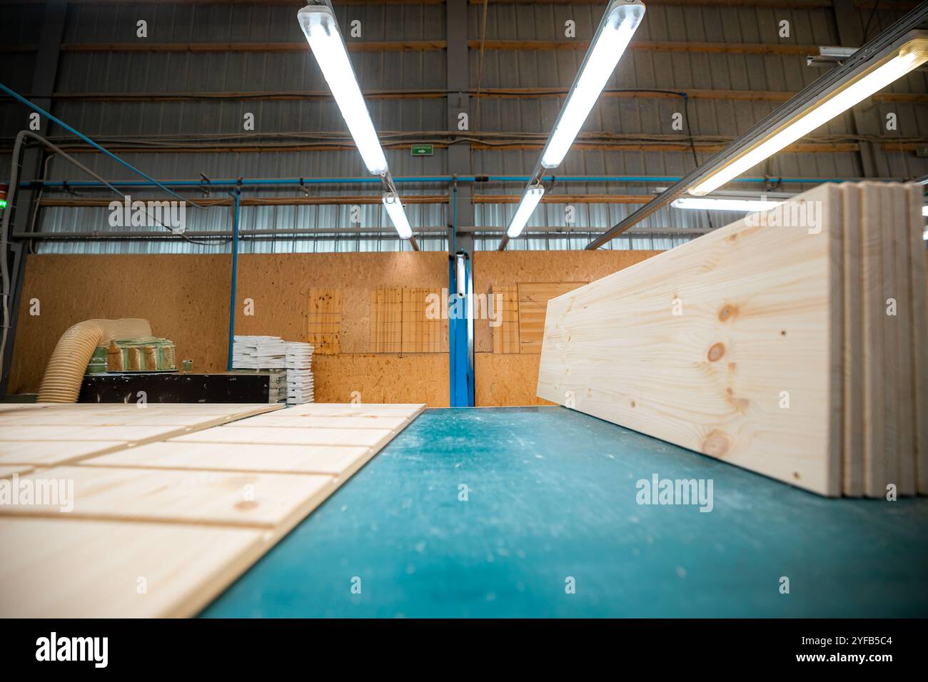 A workbench in a woodworking factory, with wooden beams and tools ready ...