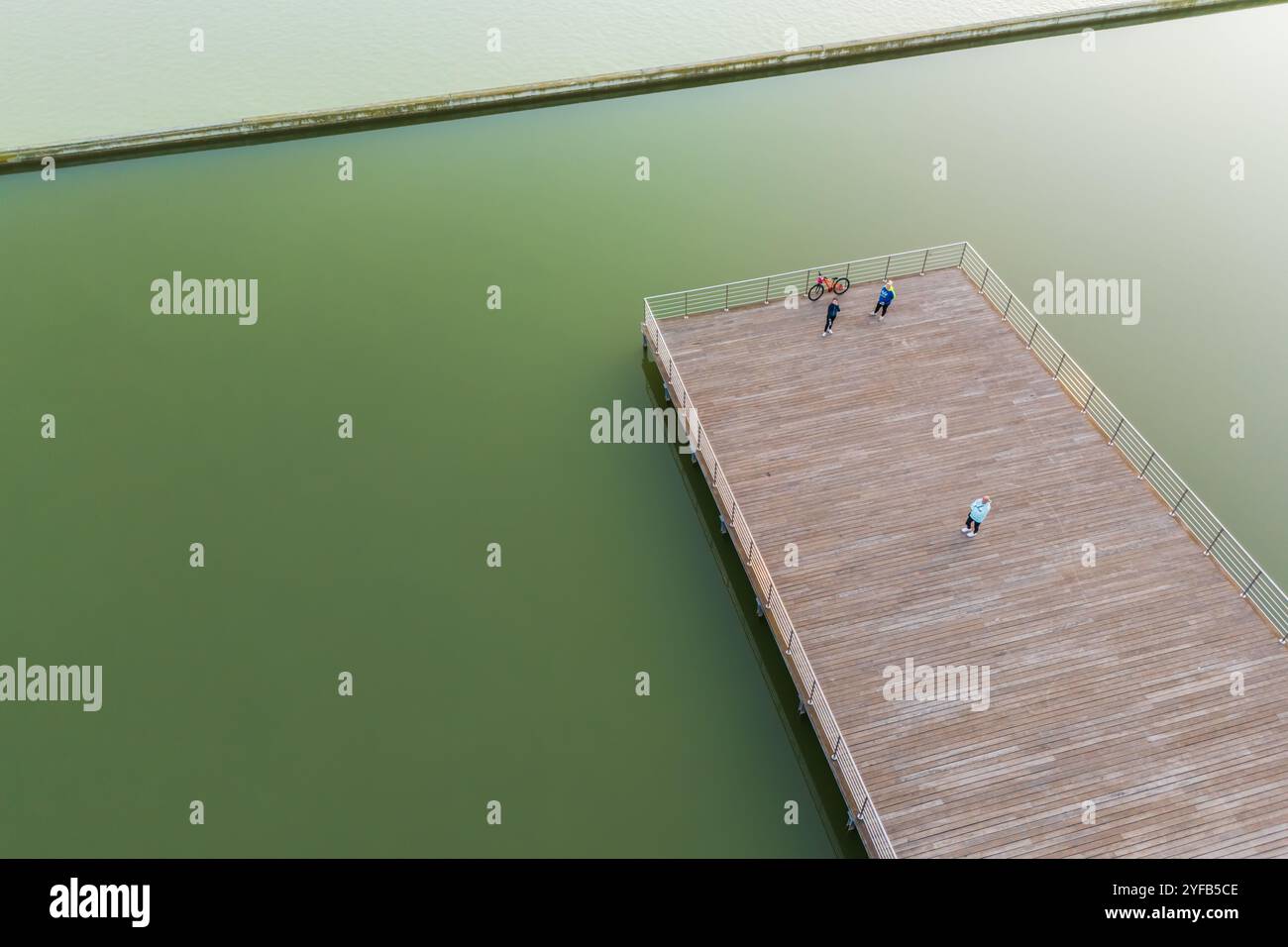Aerial view of people the wooden dock of an artificial lake Stock Photo ...
