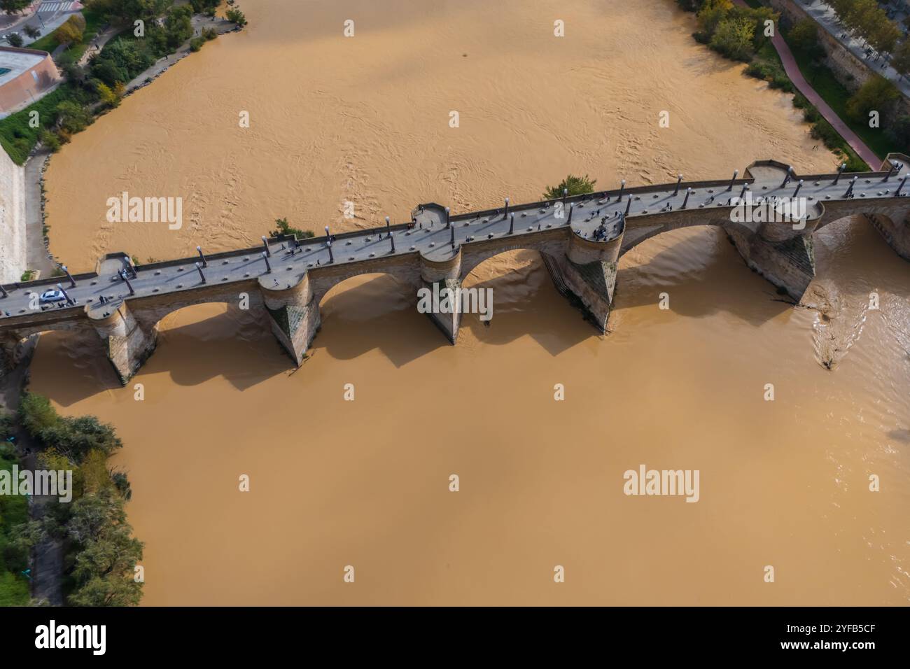 Aerial view of an abundant Ebro River passing under the Stone Bridge ...