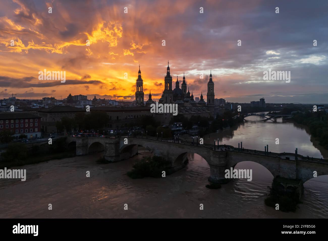 Aerial view of El Pilar Basilica Cathedral and the Ebro River at sunset ...