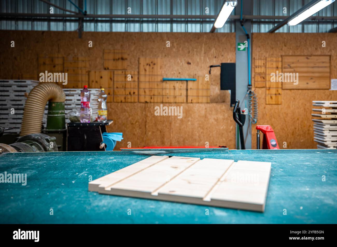 A workbench in a woodworking factory, with wooden beams and tools ready ...