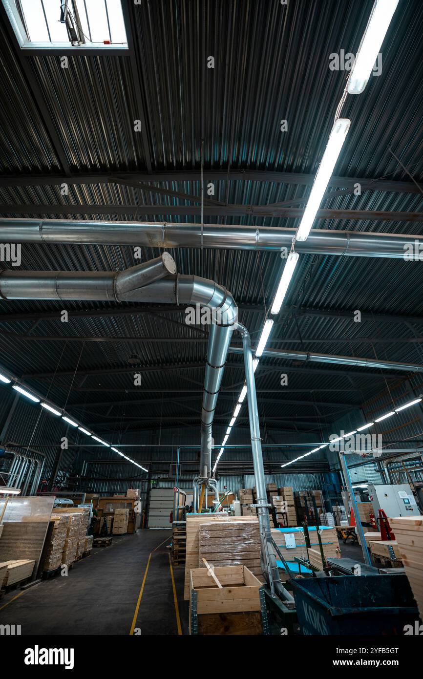 Industrial ceiling with exposed piping and lighting in a spacious ...
