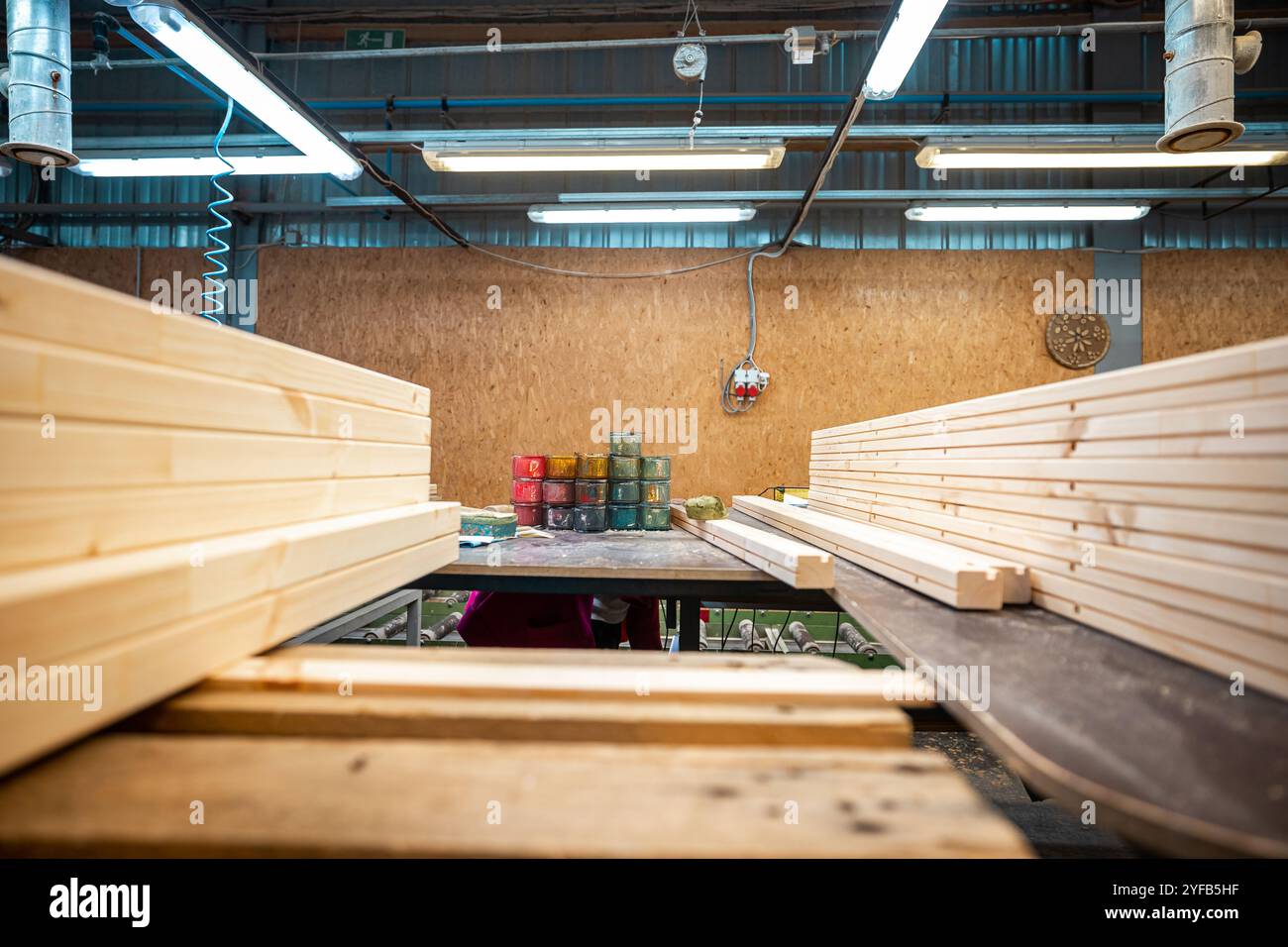 A workbench in a woodworking factory, with wooden beams and tools ready ...