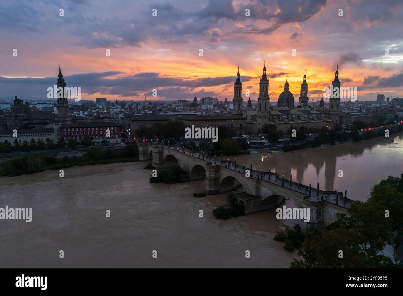 Aerial view of El Pilar Basilica Cathedral and the Ebro River at sunset ...