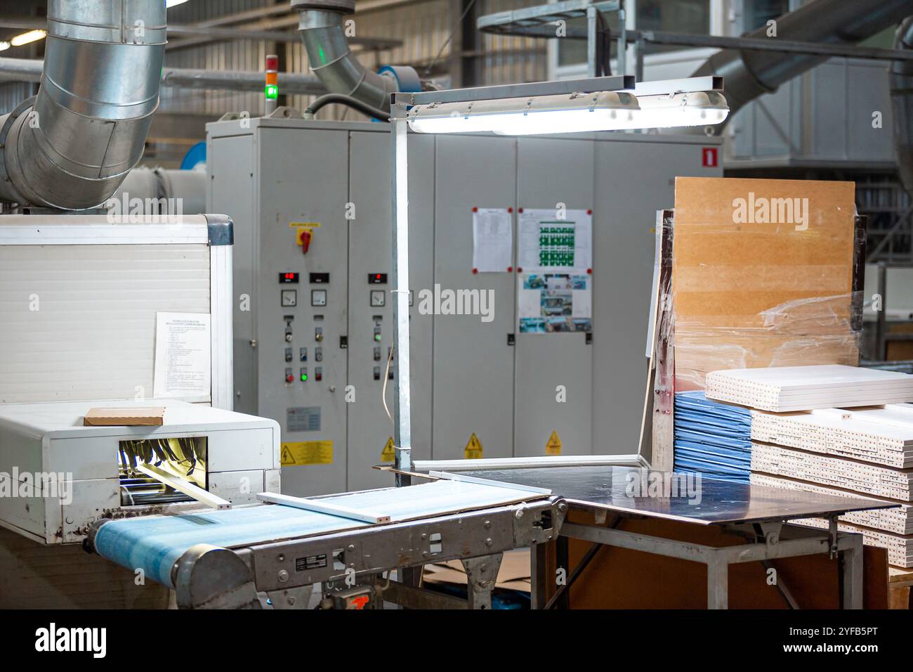 Close-up of an industrial woodworking machine in action, processing ...
