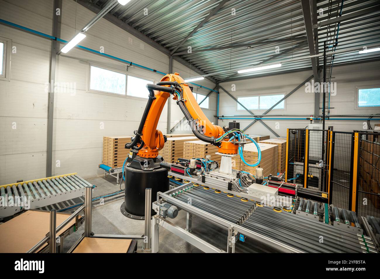 A robotic arm in a woodworking factory, equipped with suction ...