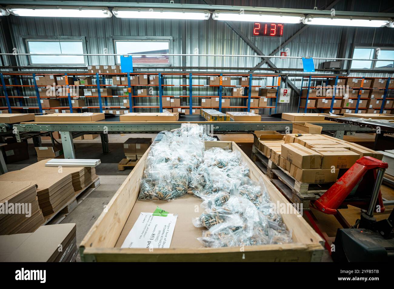 Conveyor belt and packed boxes in a well-organized industrial warehouse ...