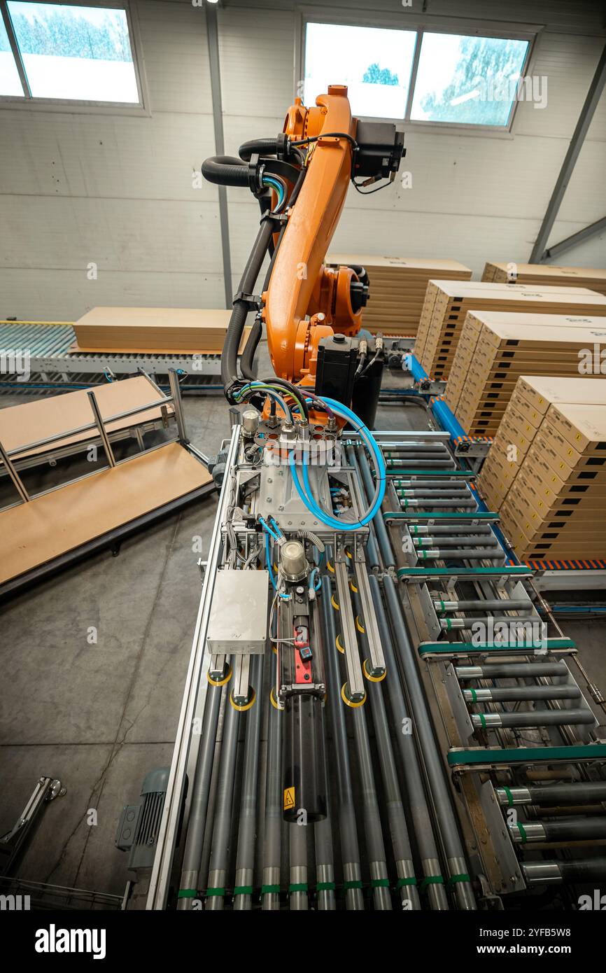A robotic arm in a woodworking factory, equipped with suction ...