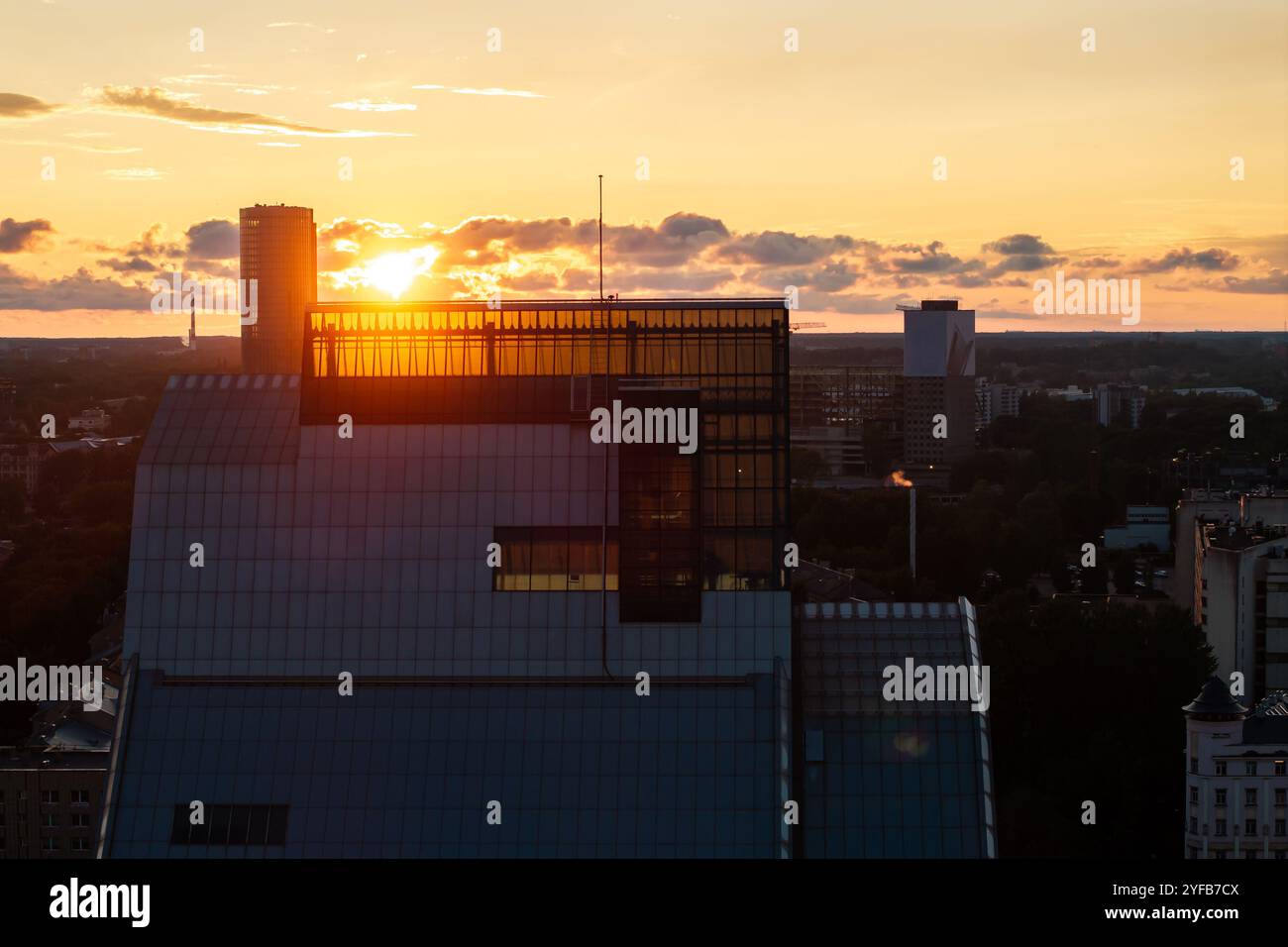 Aerial view of Riga at sunset, featuring the Daugava River, bridges ...