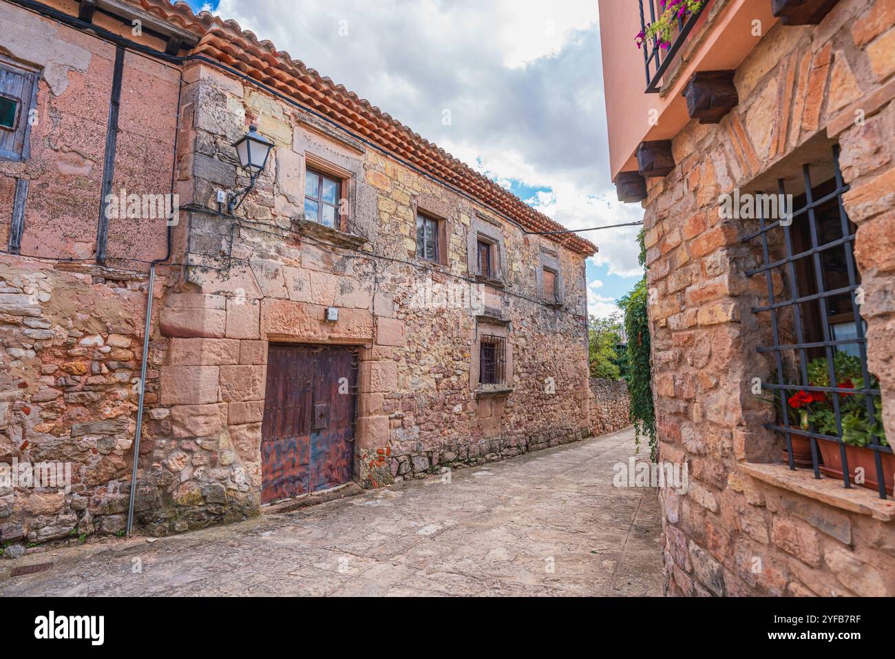 Beautiful street with rustic residential buildings in Medinaceli, a ...