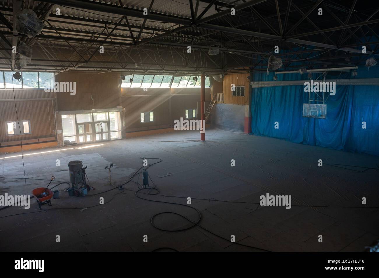 Indoor sports hall under renovation with construction equipment ...