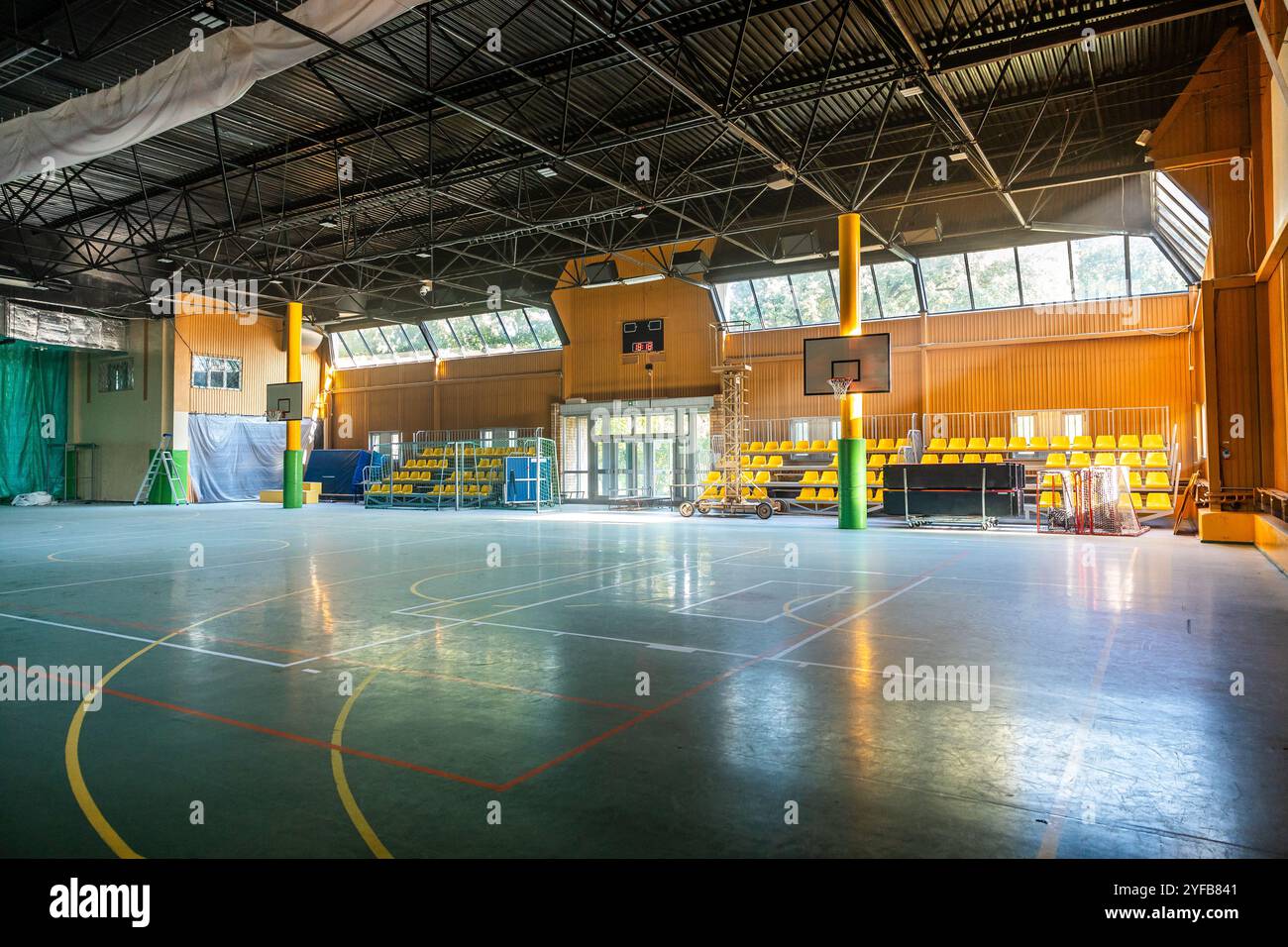 Spacious gymnasium with a basketball court, seating, and equipment ...