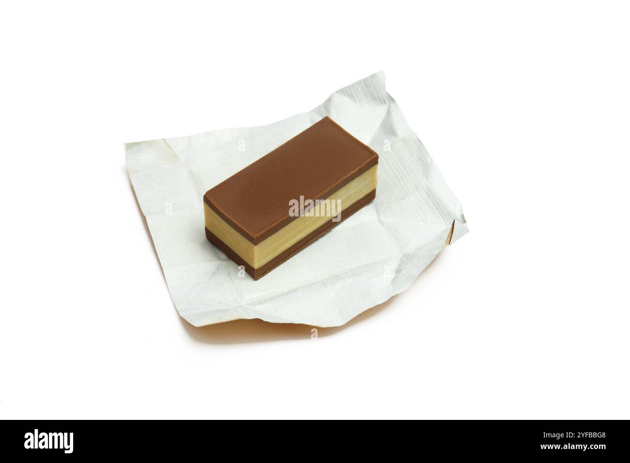 Square shape three layer chocolate hazelnuts praline unwrapped on piece ...