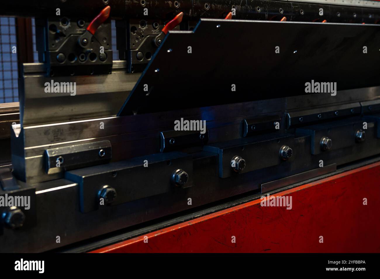 Close-up of a bending process in an industrial press machine, showing ...