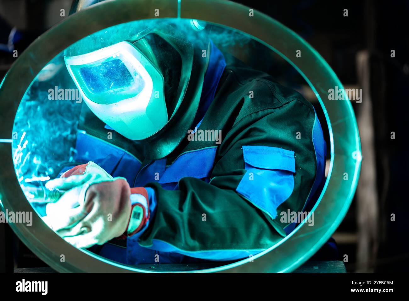 Focused welder creating strong welds on a circular metal piece, sparks ...