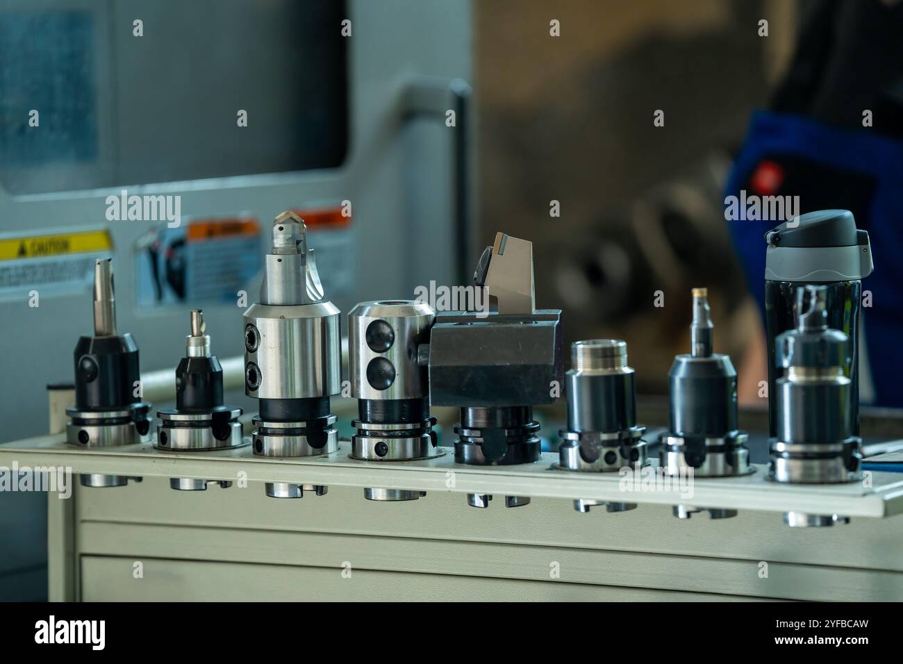 A row of various metalworking tools including drill bits and milling ...