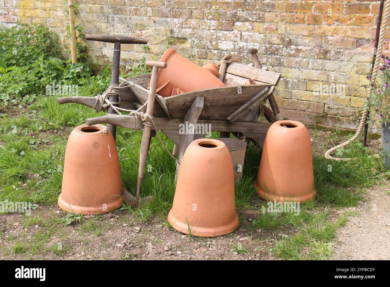 A Wheelbarrow Display with Tools and Terracotta Pots Stock Photo - Alamy