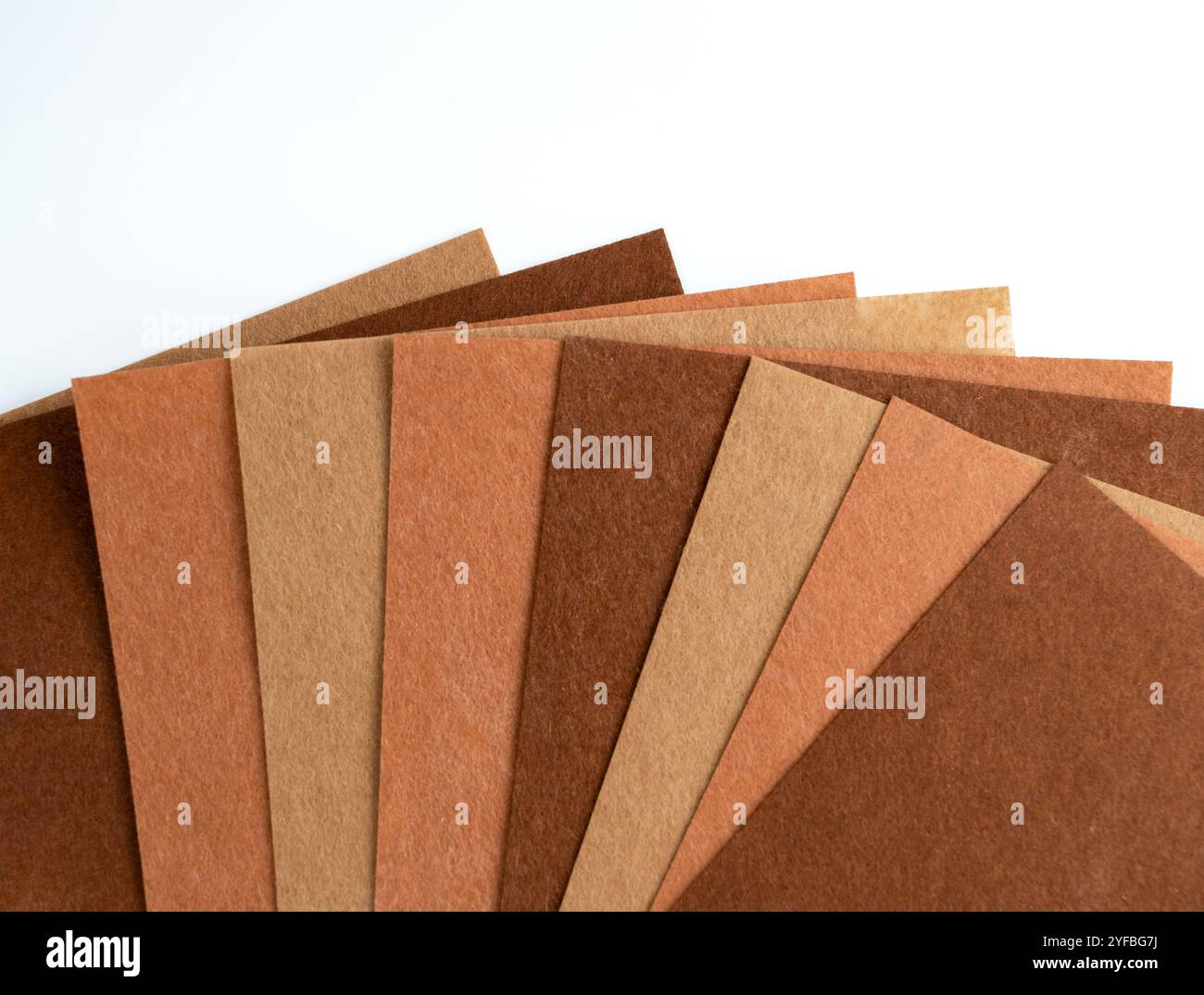 selection of brown and tan hue felt for craft making isolated on a ...