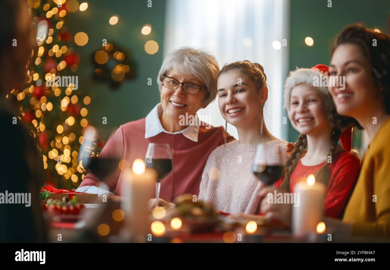 Merry Christmas. Happy family are having dinner at home. Celebration holiday and togetherness ...