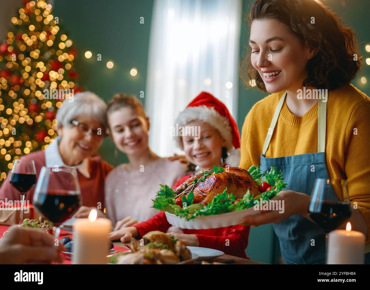 Merry Christmas. Happy family are having dinner at home. Celebration holiday and togetherness ...