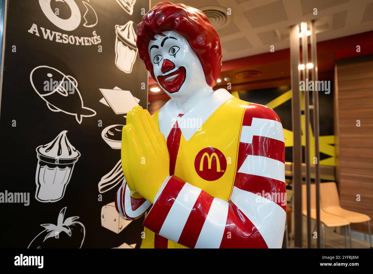 BANGKOK, THAILAND - OCTOBER 14, 2023: life-size Ronald McDonald statue greeting customers with ...