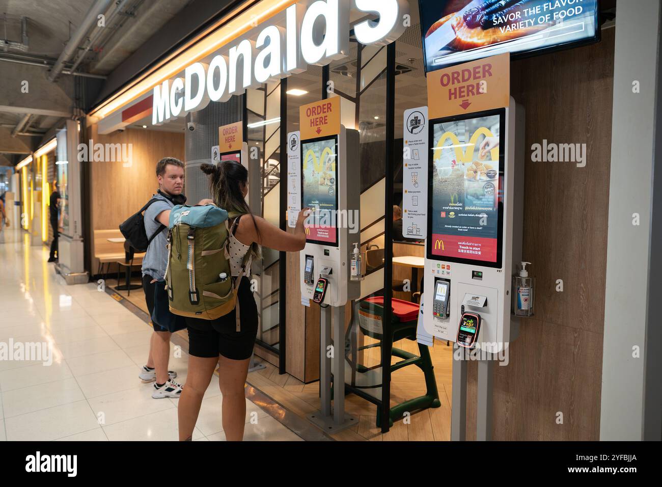 BANGKOK, THAILAND - OCTOBER 26, 2023: people use self-service kiosks at ...