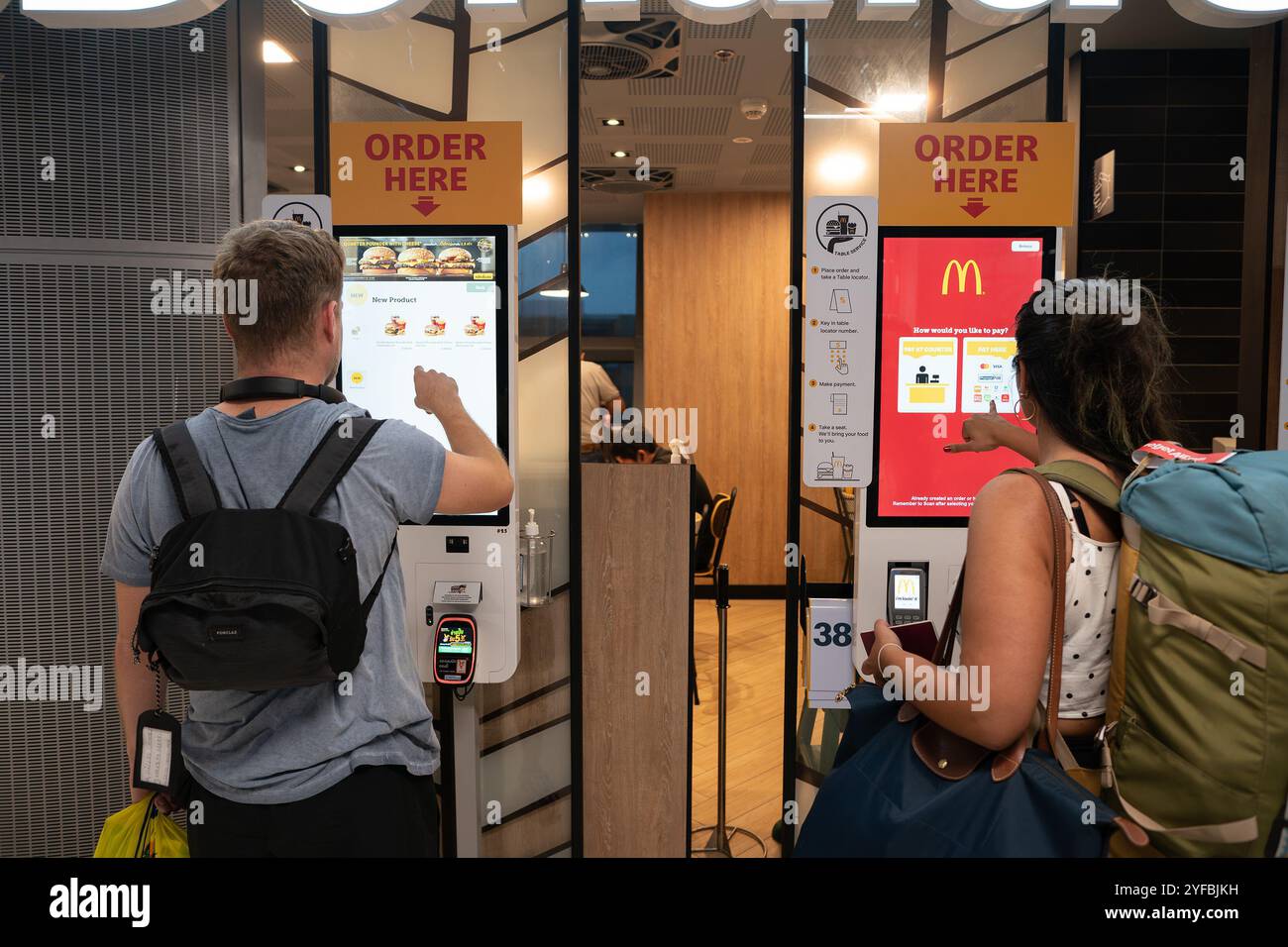 BANGKOK, THAILAND - OCTOBER 26, 2023: people use self-service kiosks at ...