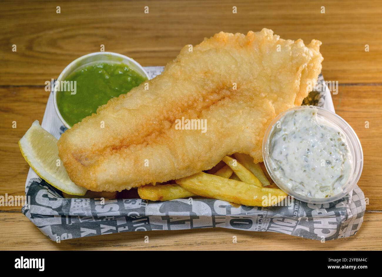 Traditional fish and chips wrapped in newspaper form a chip shop Stock ...