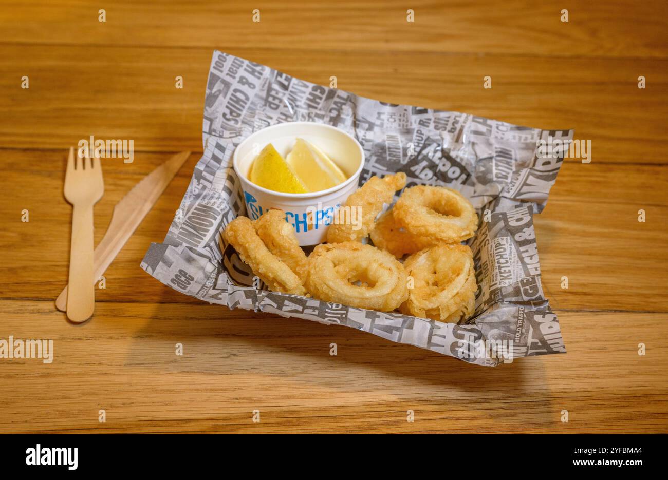 Calamari and chips wrapped in newspaper form a chip shop Stock Photo ...