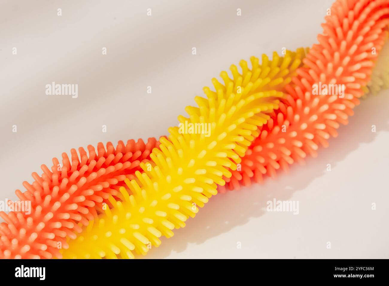 Two multi-colored spirals are woven together Stock Photo - Alamy