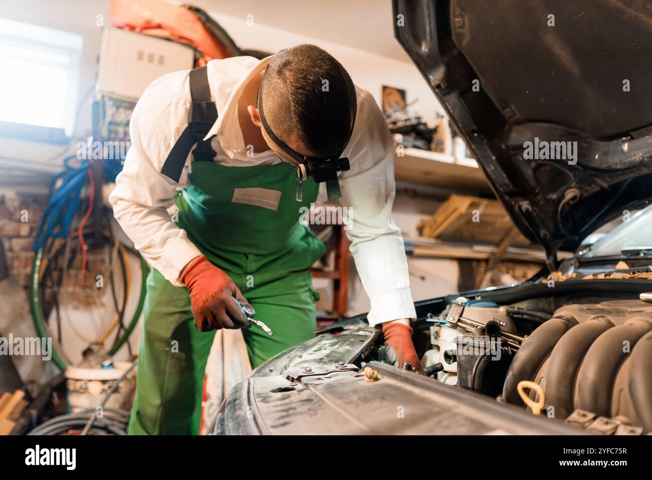 Mechanic performing detailed inspection repair hi-res stock photography ...