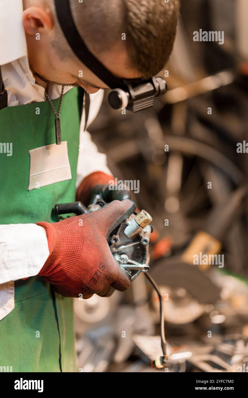 Skilled Mechanic Repairing Engine Component in Workshop Stock Photo - Alamy