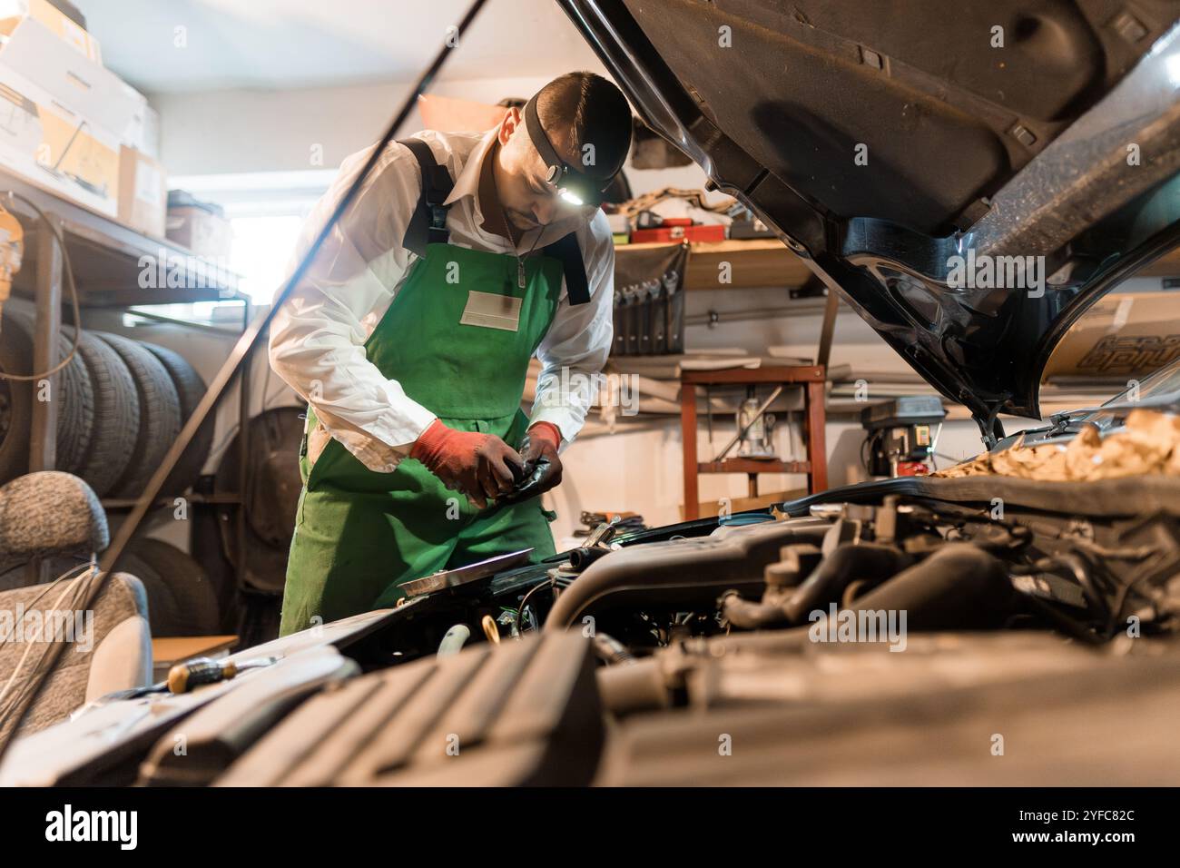 Skilled Mechanic Performing Detailed Engine Maintenance in a Well ...
