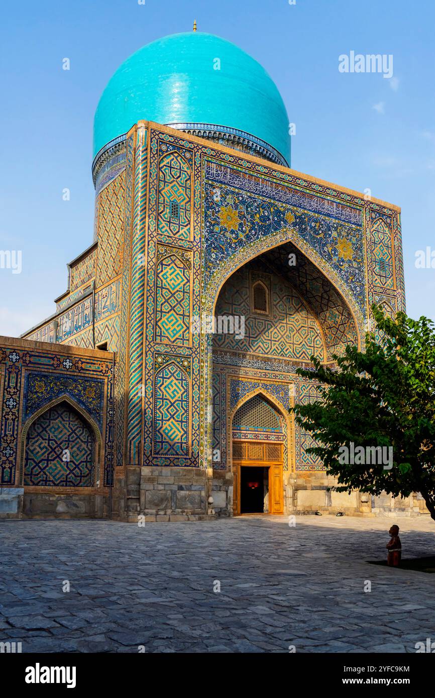 Courtyard of the Sher-Dor Madrasah the walls are decorated with bright ...
